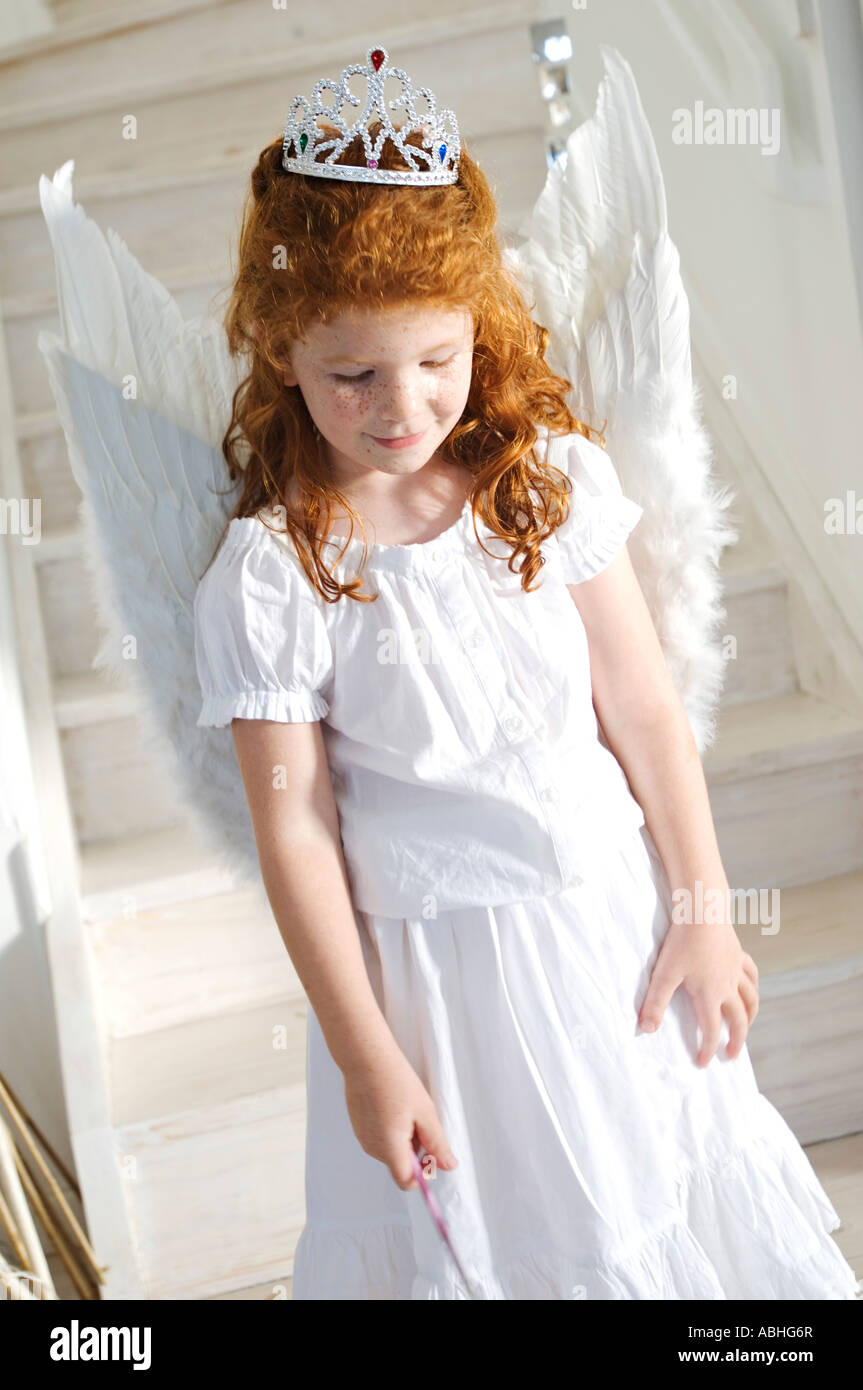 Little girl in an angel costume, indoors Stock Photo - Alamy