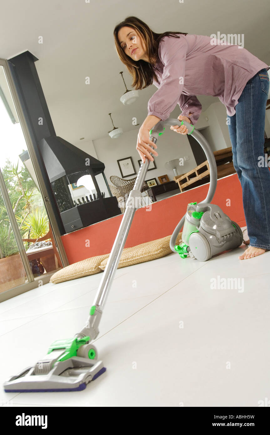 Woman vacuuming, indoors Stock Photo - Alamy