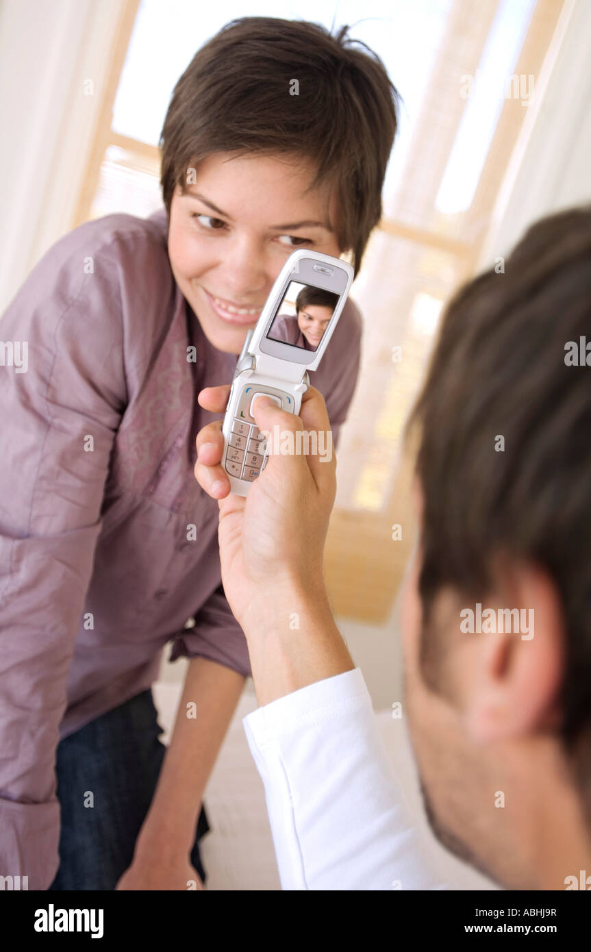Man photographing young woman with camera phone Stock Photo - Alamy
