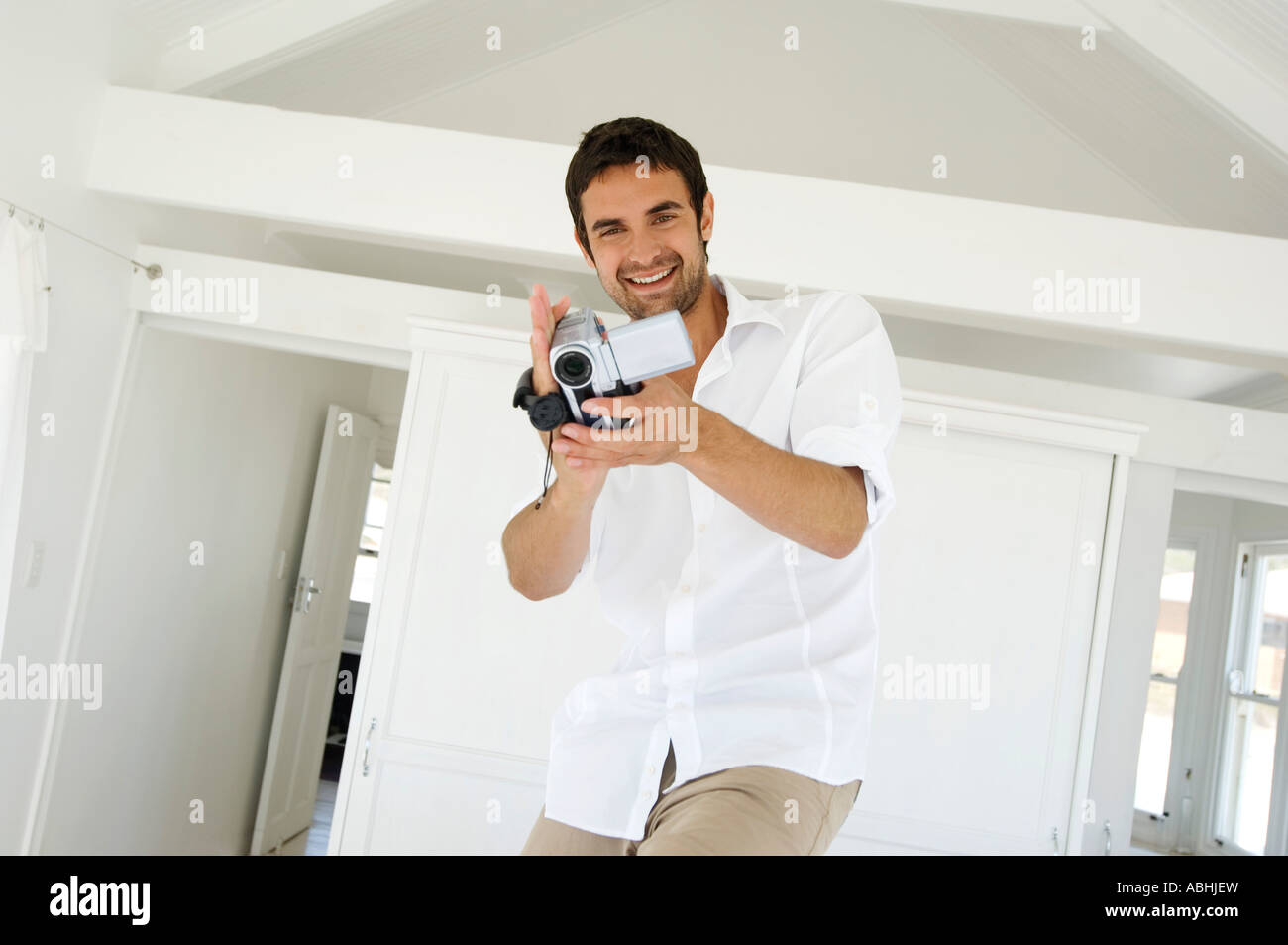 Young man using camcorder Stock Photo - Alamy
