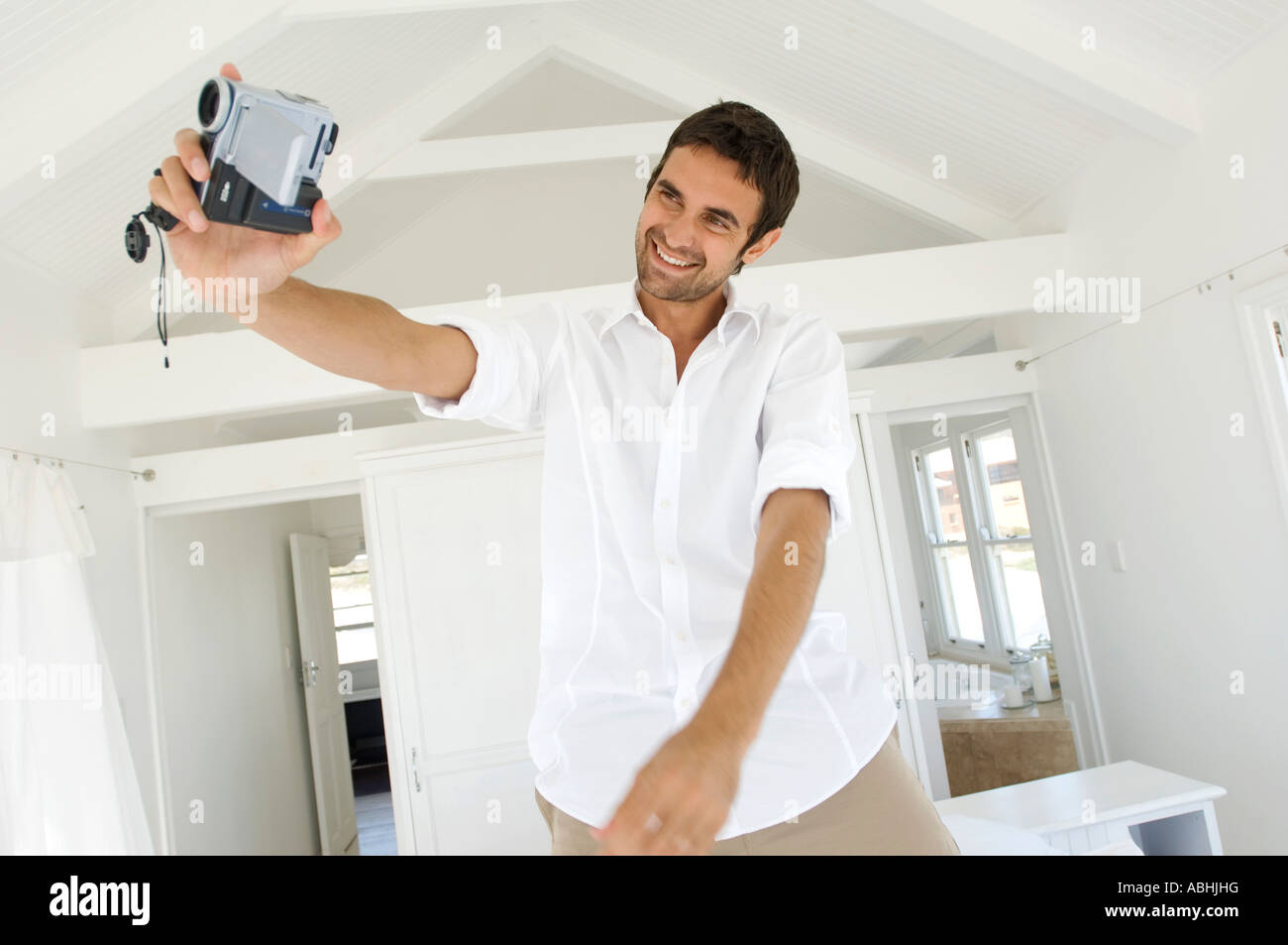 Young man using camcorder Stock Photo - Alamy