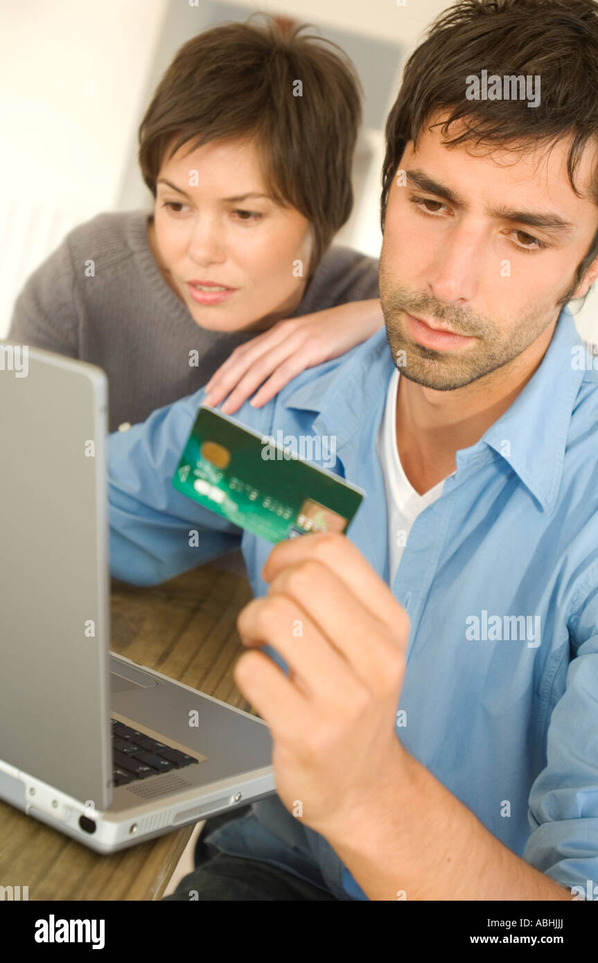 Young couple using credit card on internet Stock Photo - Alamy