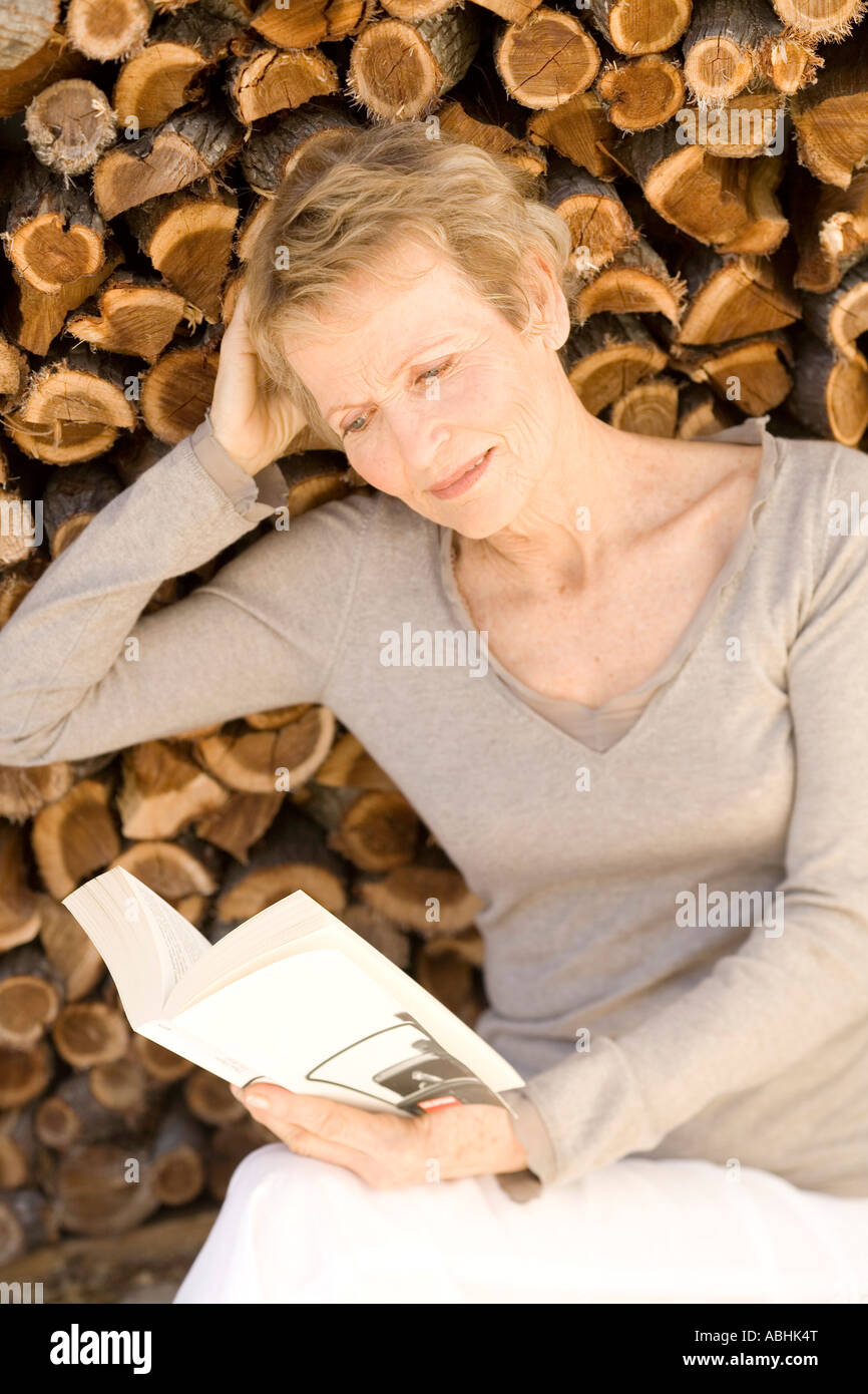 Senior woman reading a book Stock Photo - Alamy
