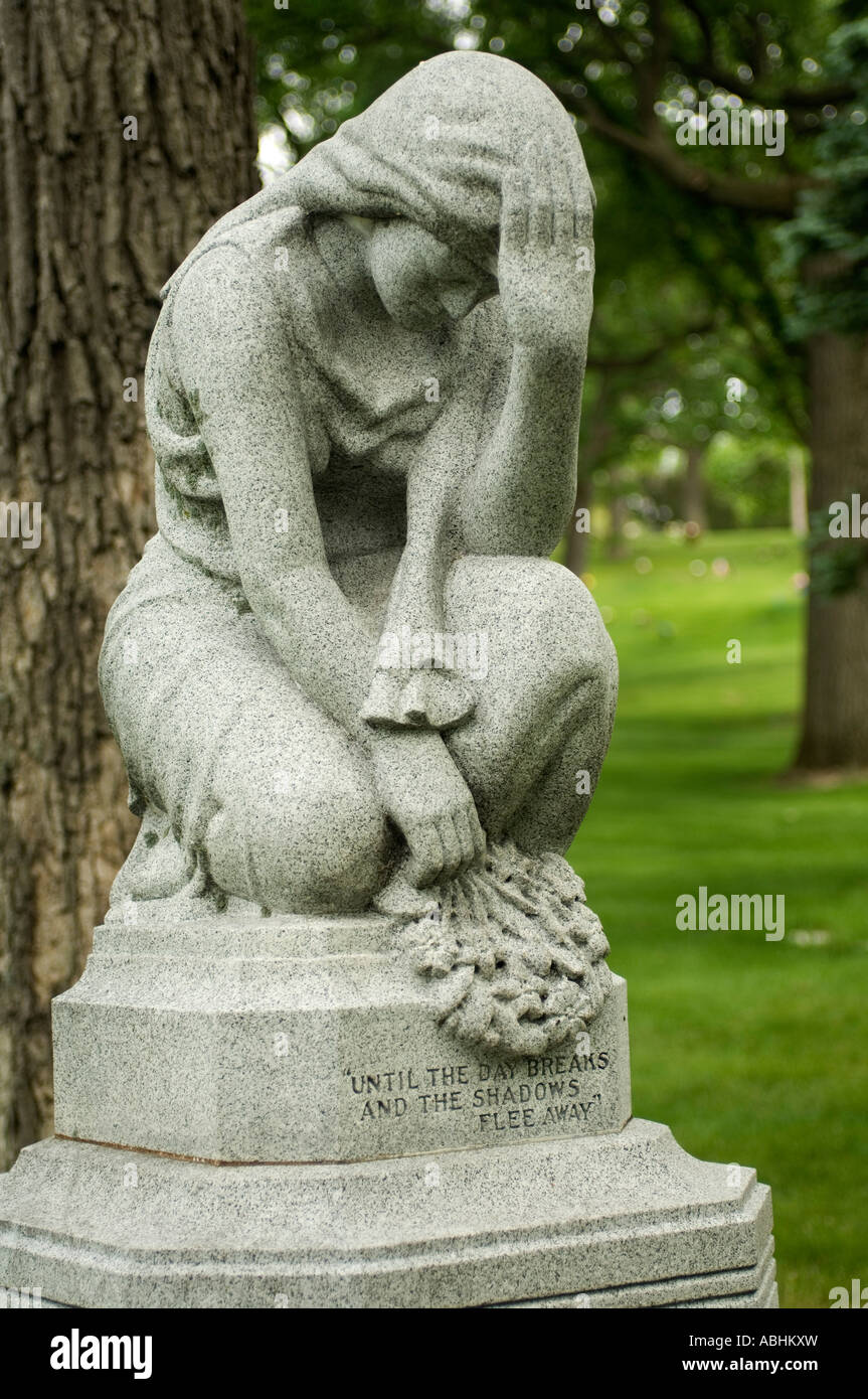 A mourning statue in a cemetery Stock Photo - Alamy