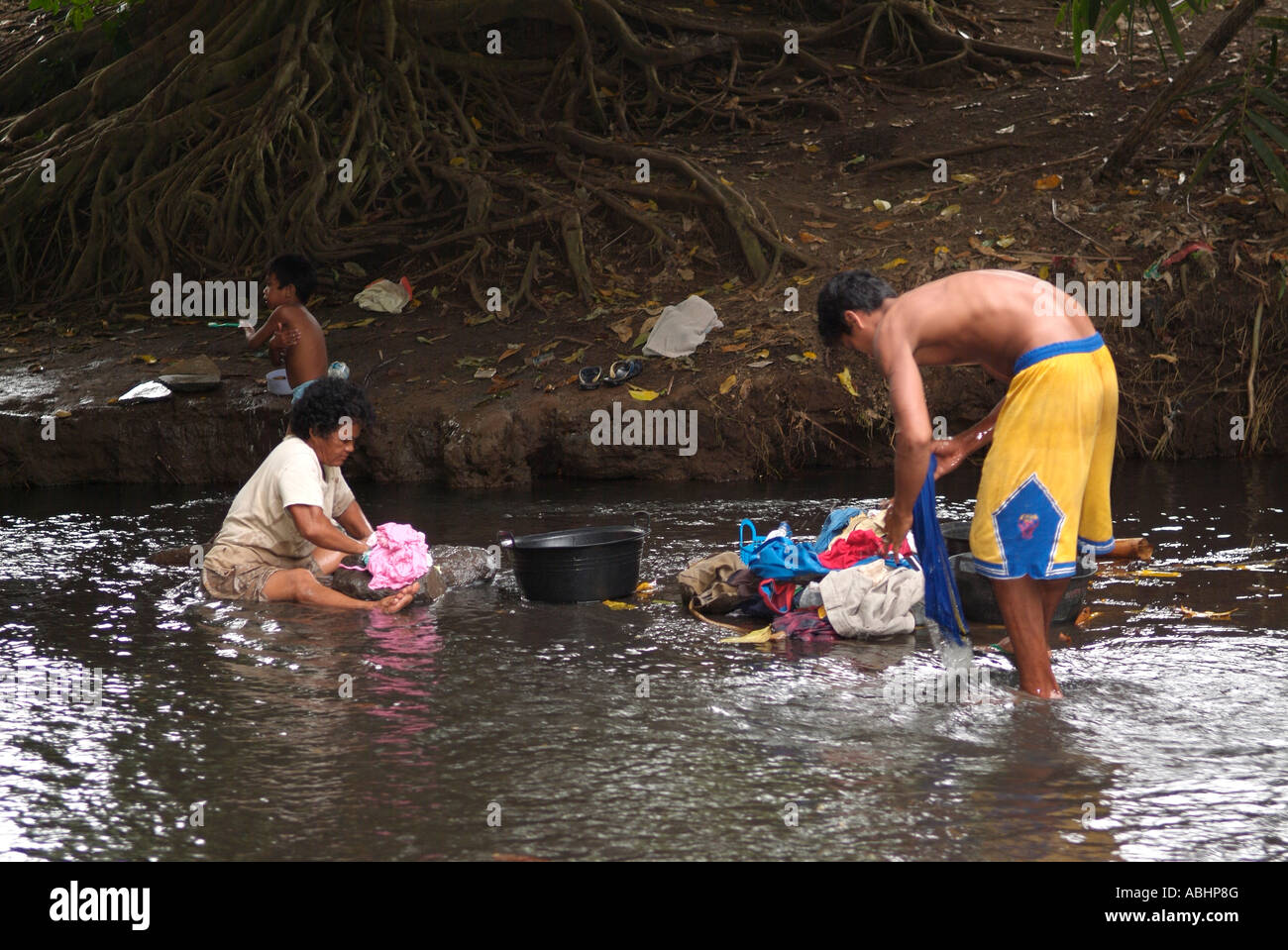 Family washing clothes in a river near Manado, North Sulawesi Stock ...