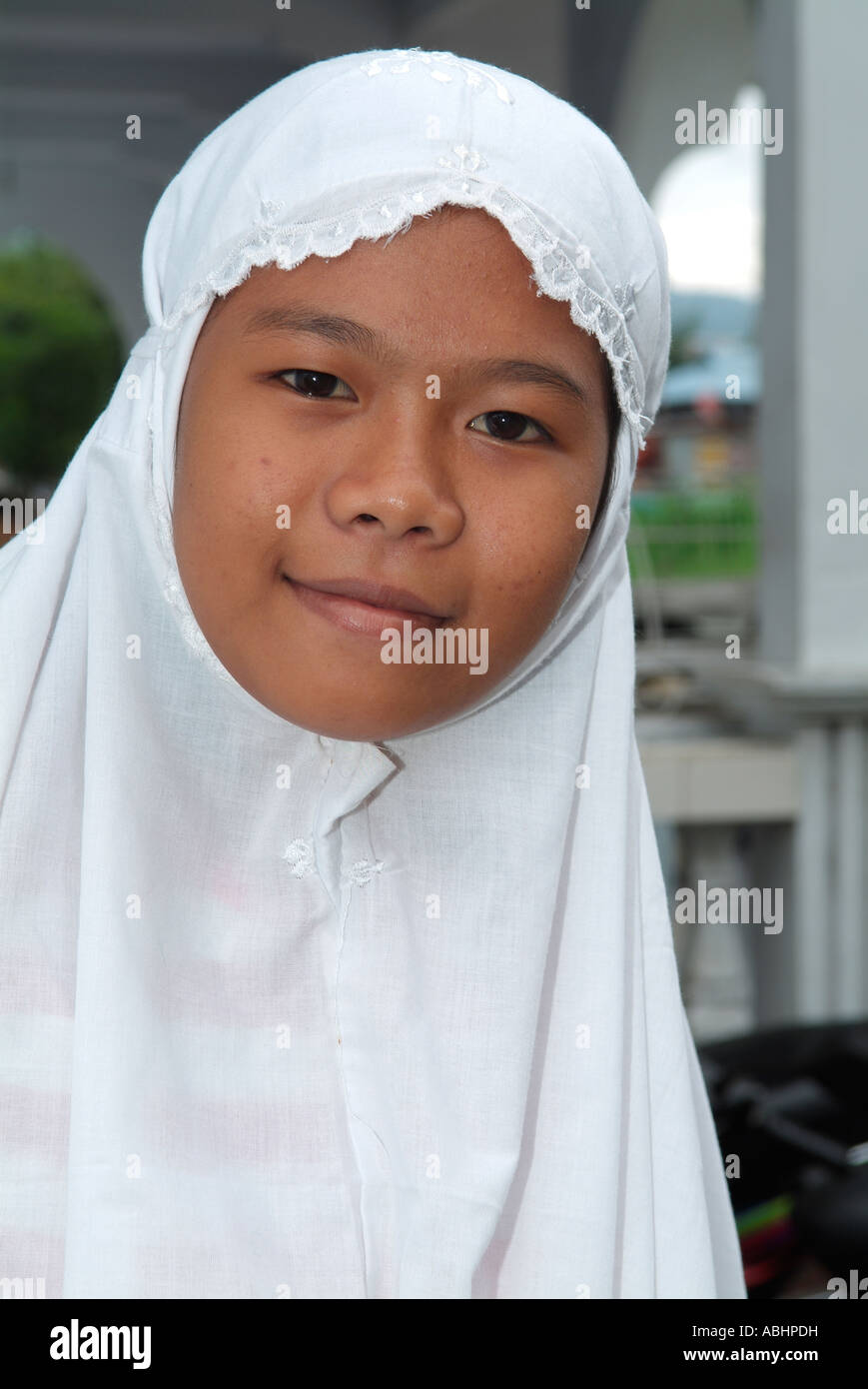 Portrait of an muslim Indonesian girl smiling in Manado Stock Photo - Alamy