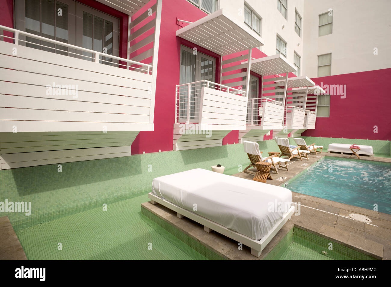 Hotel pool with deckchairs and bed beside the water at the Clinton Art ...