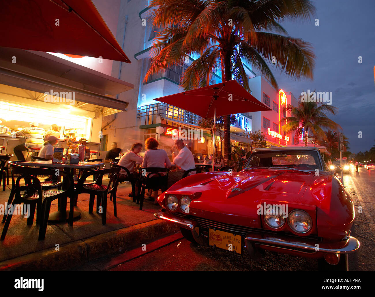 Classic car parking beside a sidewalk cafe at Ocean Drive South Beach ...