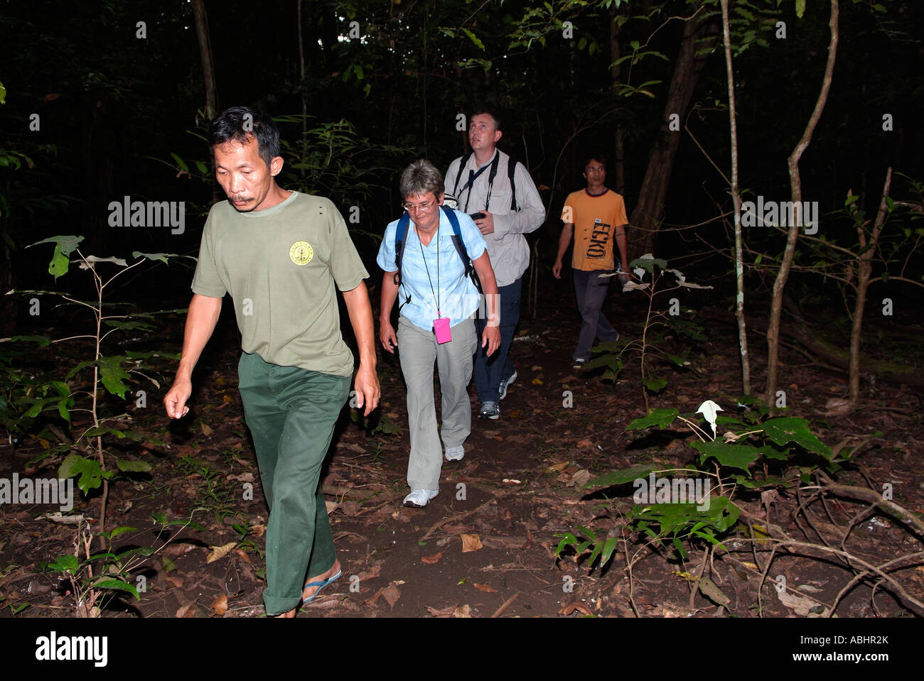 People leading by an indonesian guide in the jungle Stock Photo - Alamy