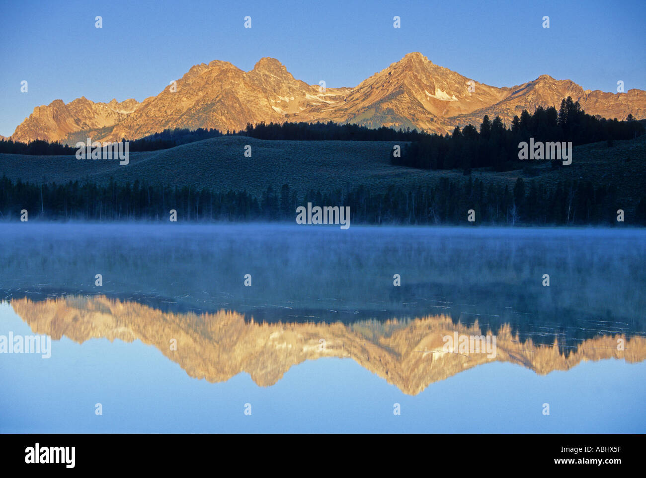 Little Redfish Lake reflects the Sawtooth Mountain Range at surise in ...