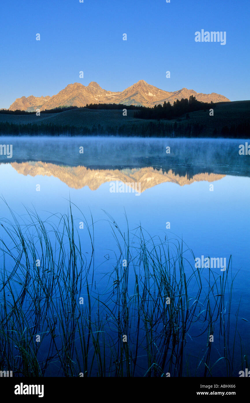 Little Redfish Lake reflects the Sawtooth Mountain Range at surise in ...