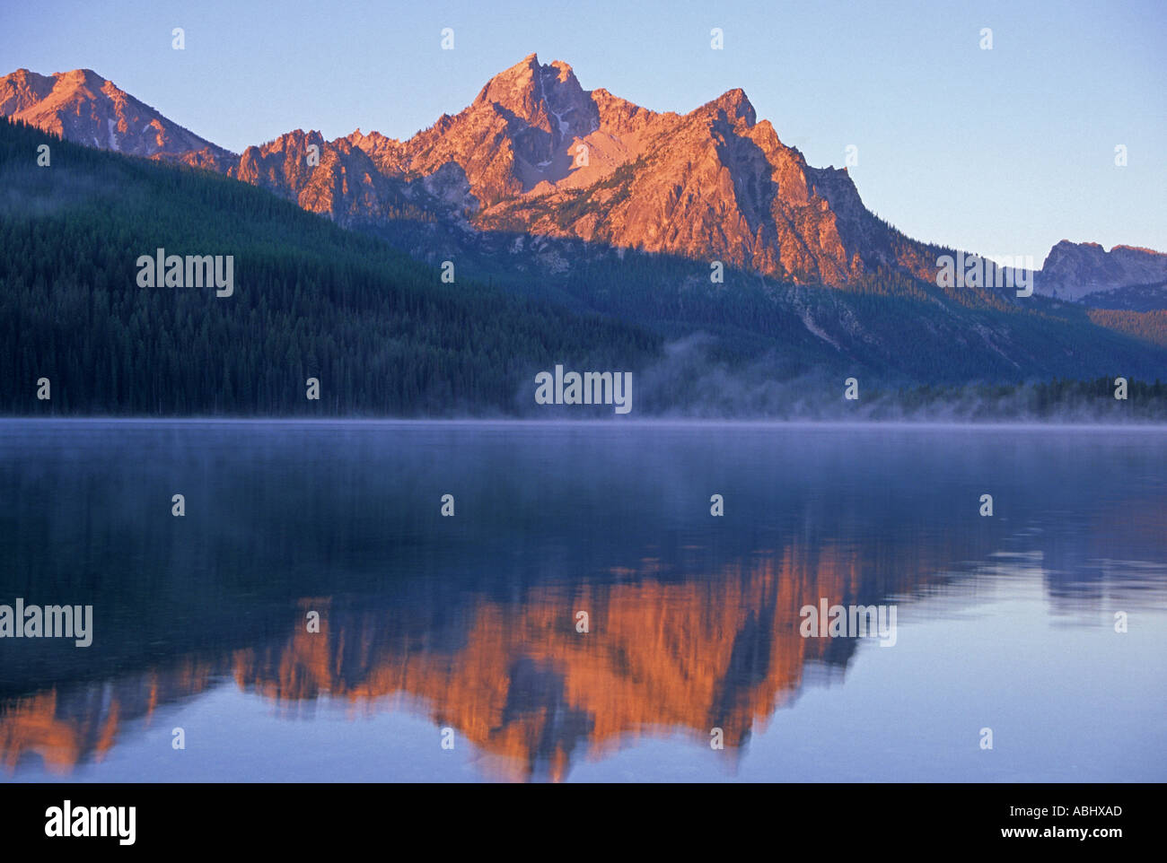 Sunrise colors the peaks of the Sawtooth Mountain Range above Stanley ...
