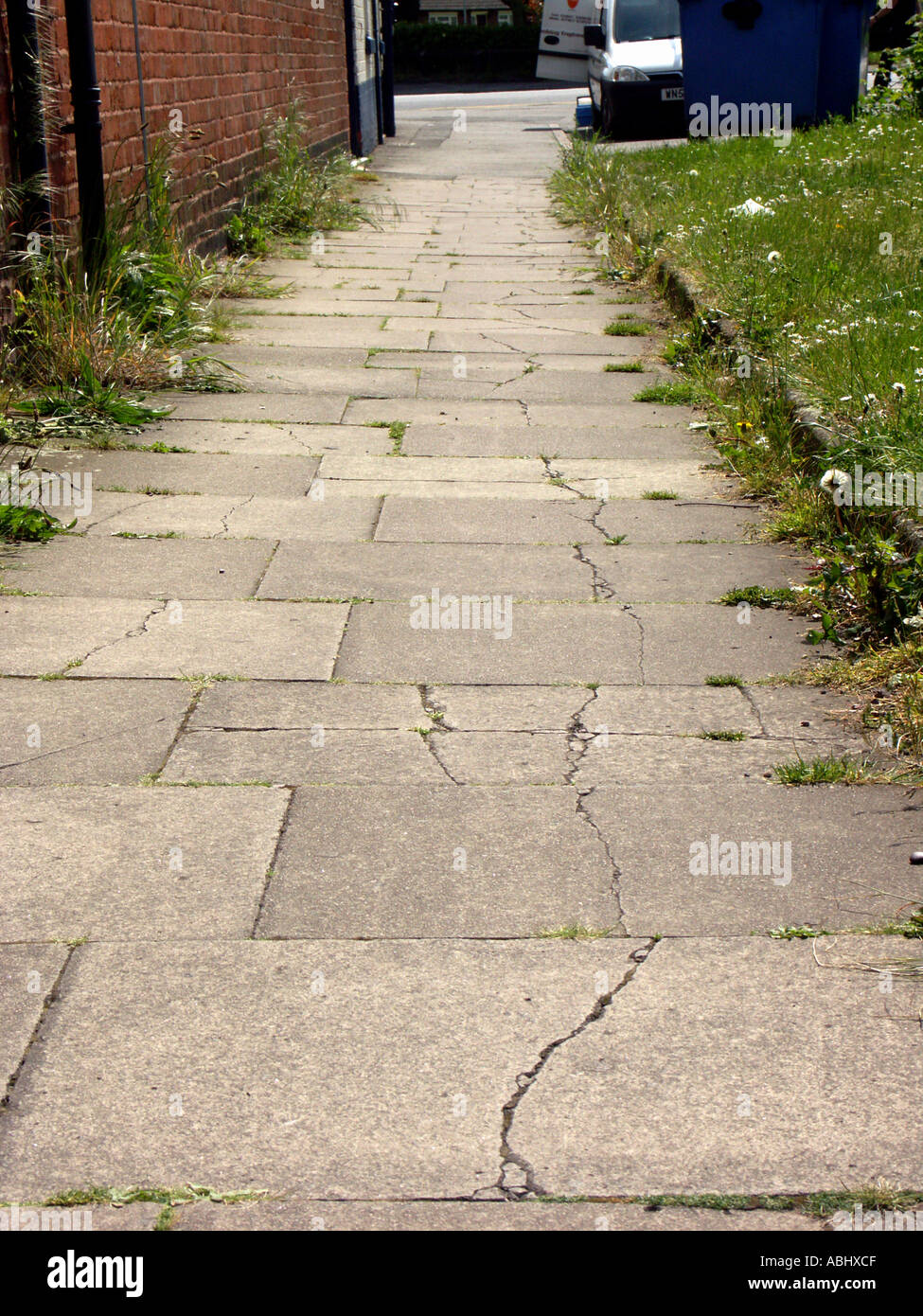 Cracked and damaged paving slabs on a public footpath making them a ...