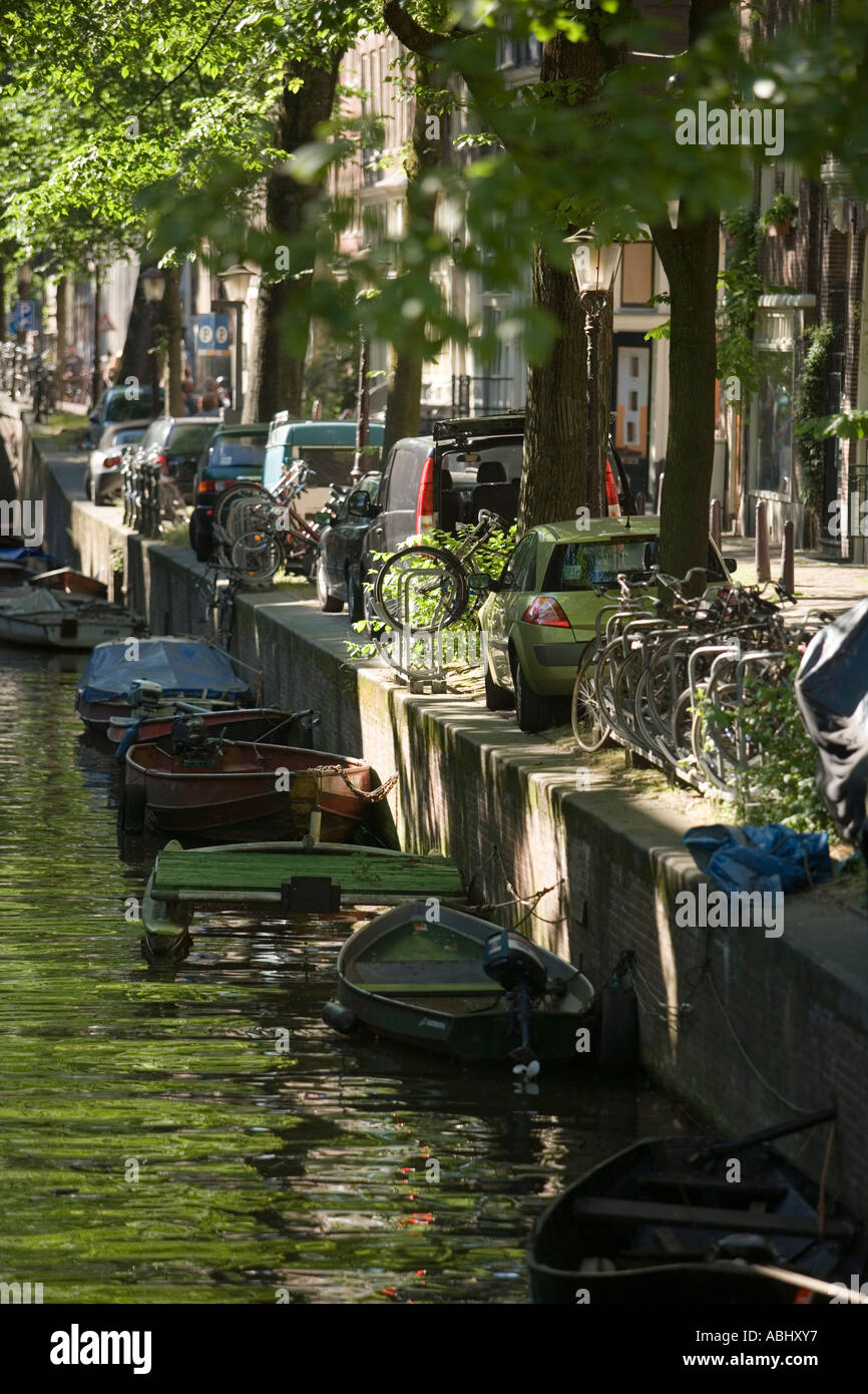 A small leisure boat passing house boats on Oude Schans Amsterdam ...
