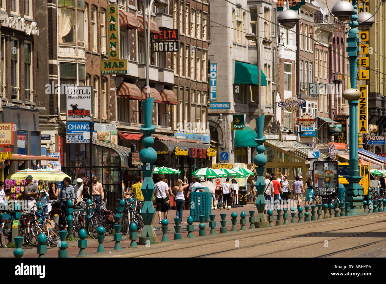 People walking over shopping street with a lot of souvenir shops Damrak ...