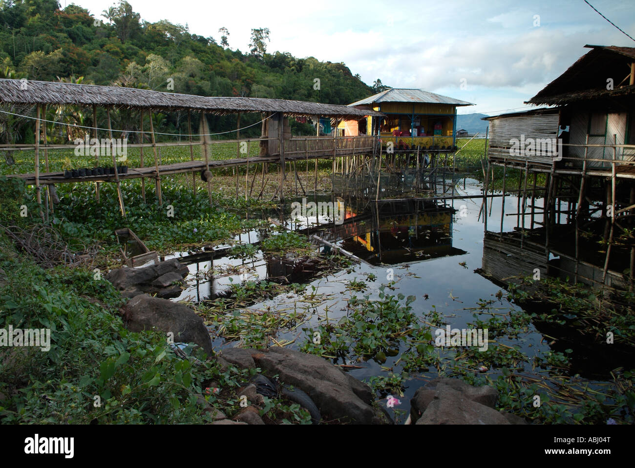 Pile houses built on a lake near Manado, Indonesia Stock Photo - Alamy