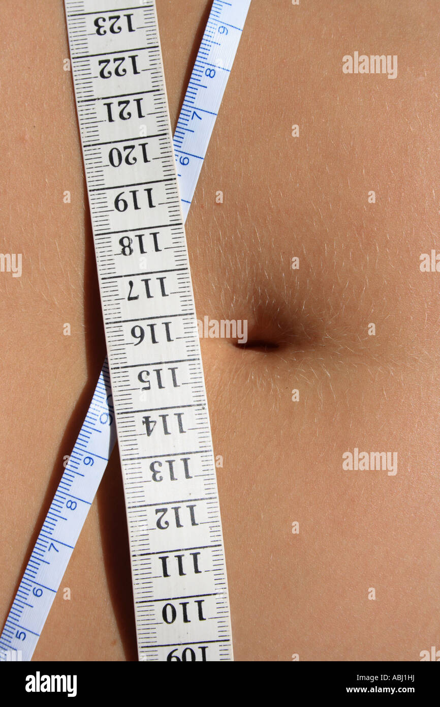 young woman measuring waist. Photo by Willy Matheisl Stock Photo - Alamy