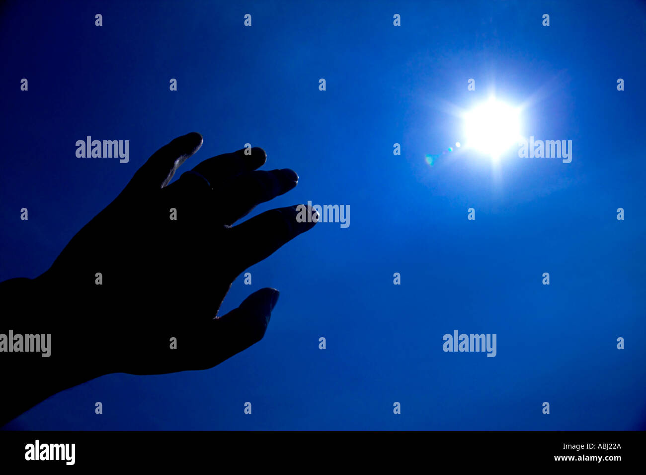 Hand spread to shade bright burning sun in blue sky Stock Photo - Alamy