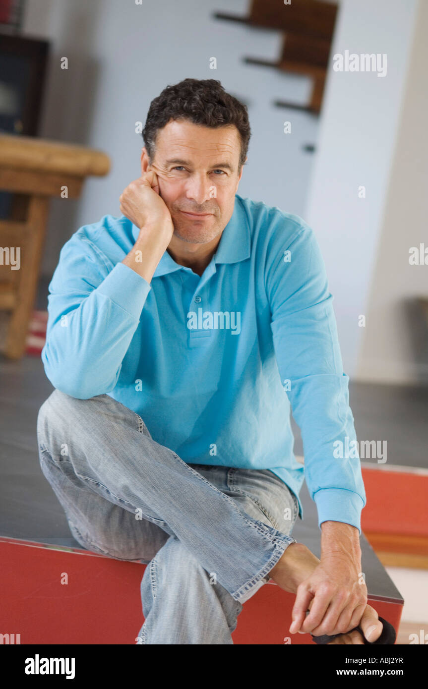 Man sitting, indoors Stock Photo - Alamy