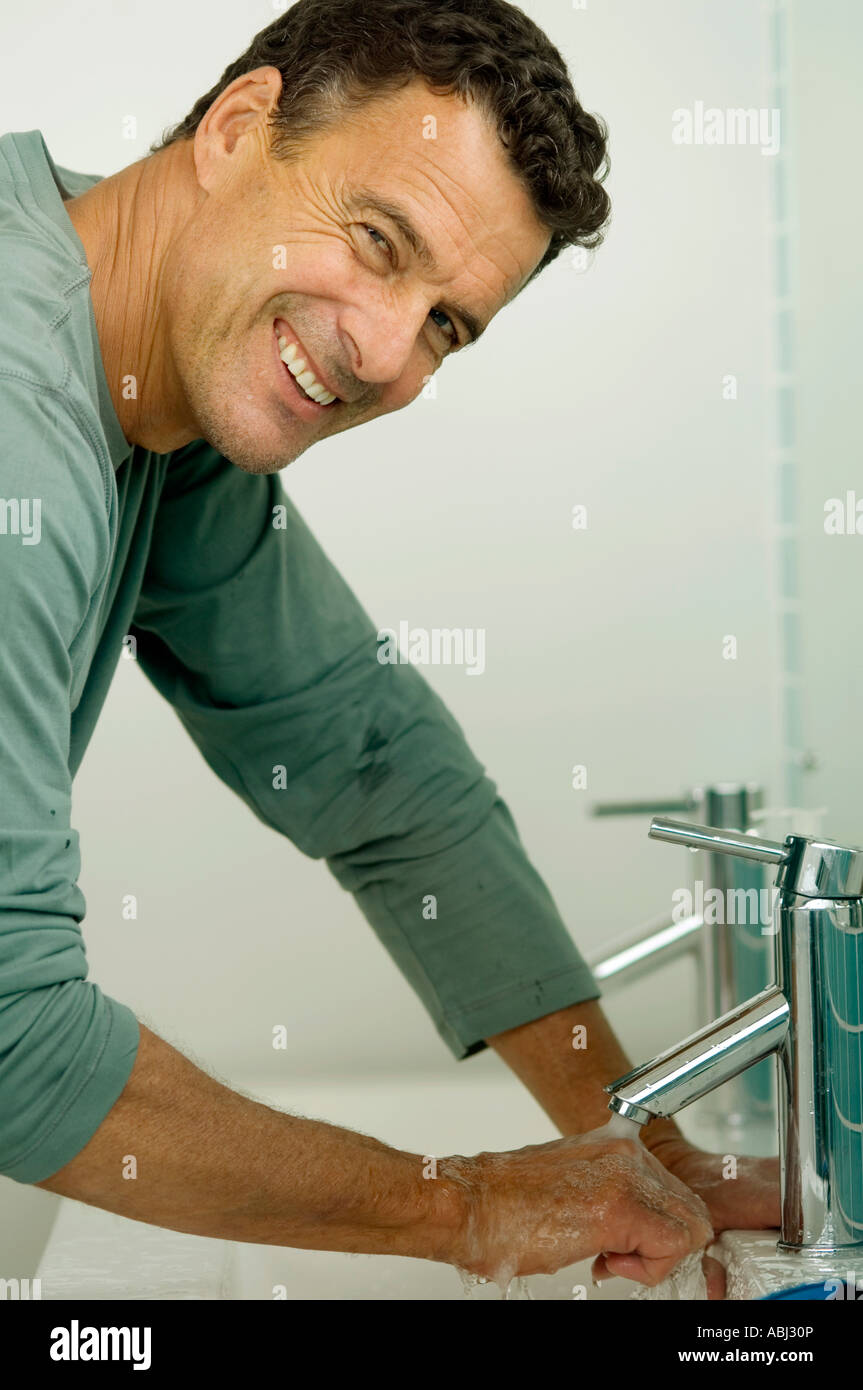 Man washing his hands, indoors Stock Photo - Alamy
