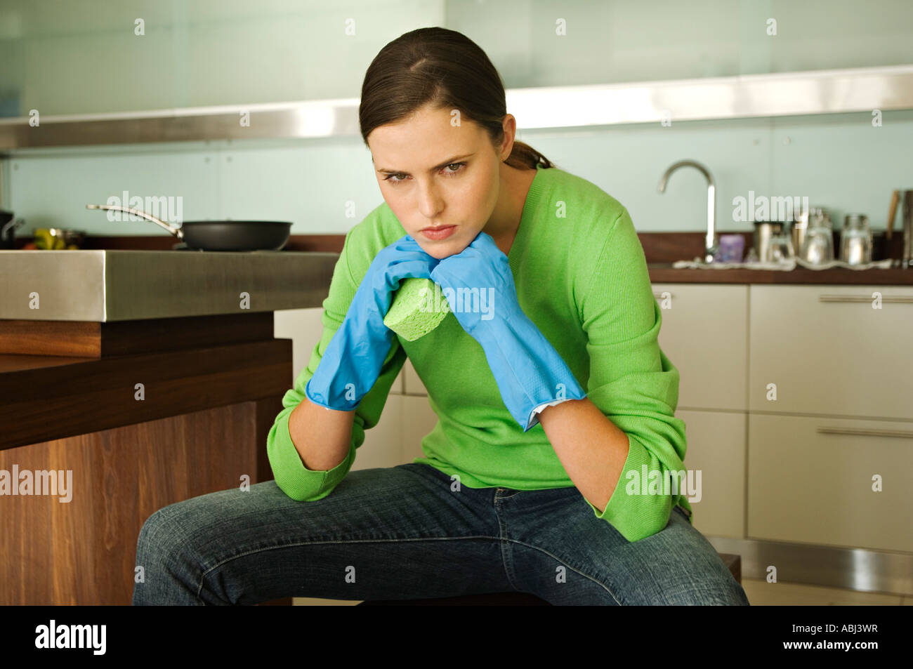 Young woman looking angry in kitchen Stock Photo - Alamy