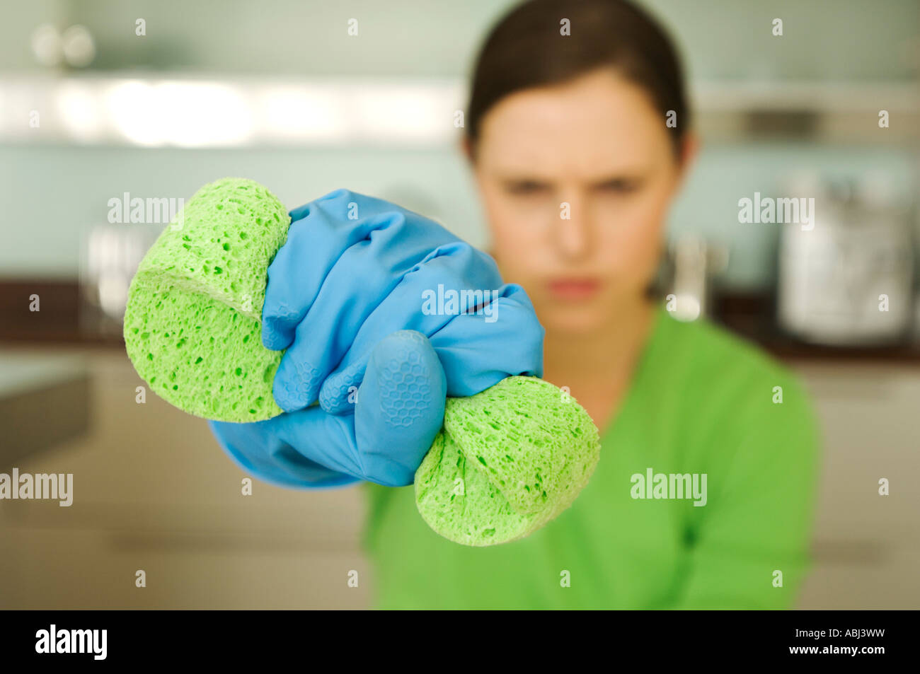 Young woman wringing sponge Stock Photo - Alamy