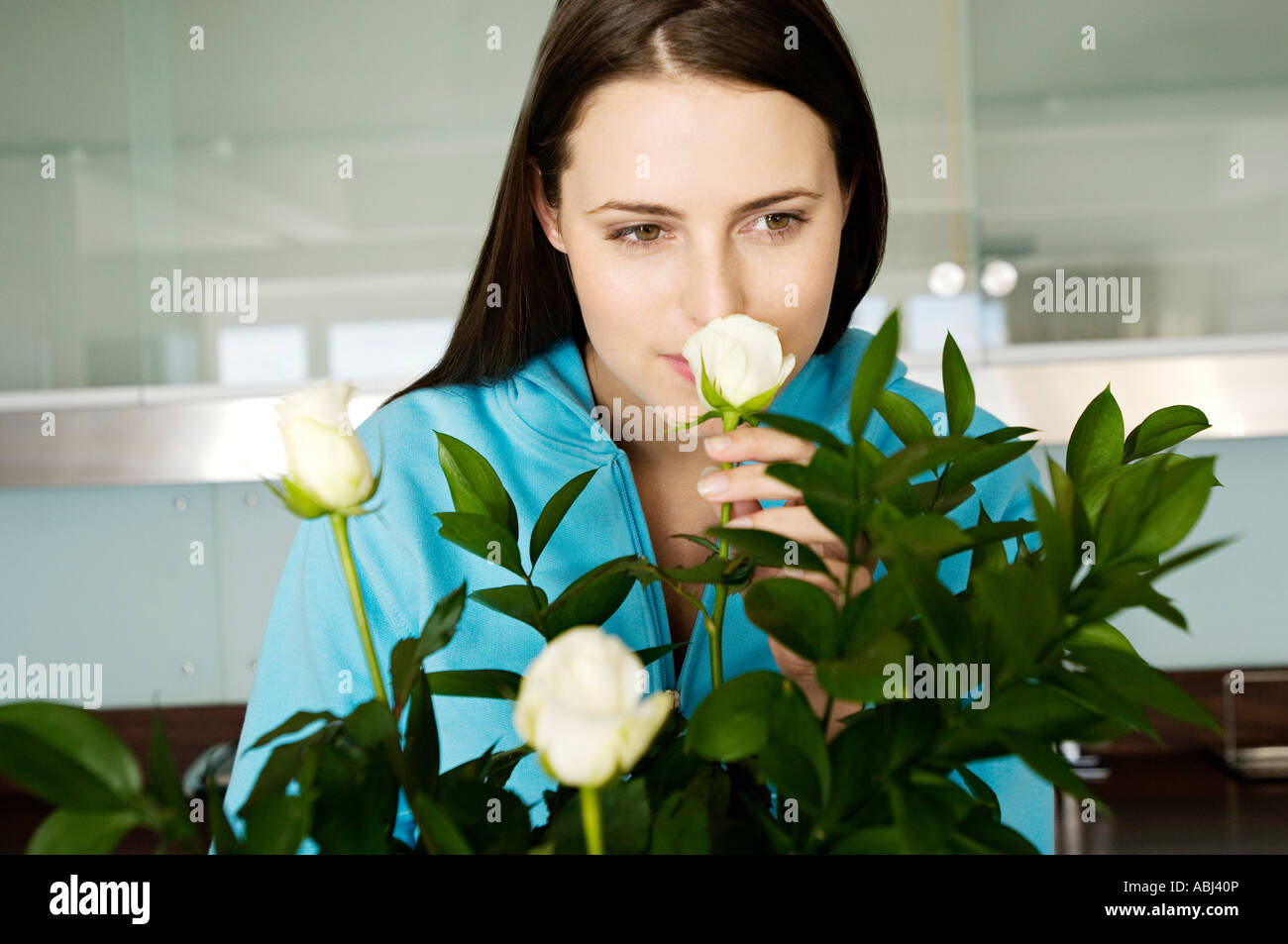 Portrait of young woman smelling rose Stock Photo - Alamy