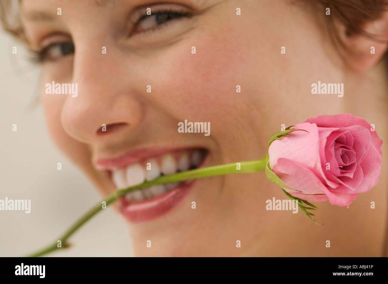 Young woman biting rose hi-res stock photography and images - Alamy