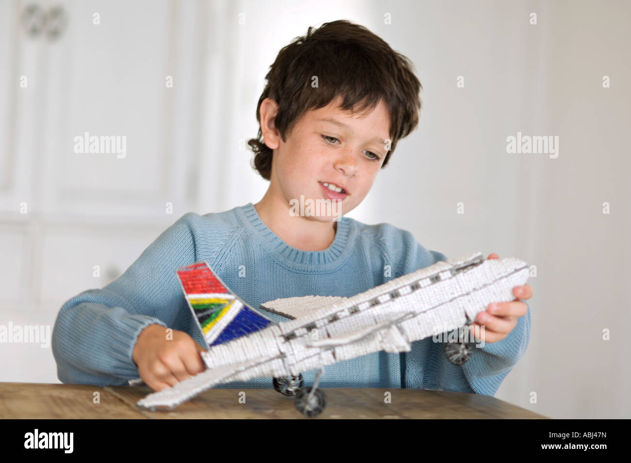 Little boy playing with model aeroplane Stock Photo - Alamy