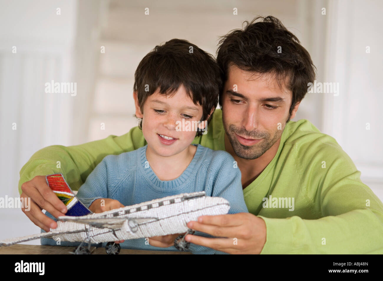 Father and son playing with model aeroplane Stock Photo - Alamy