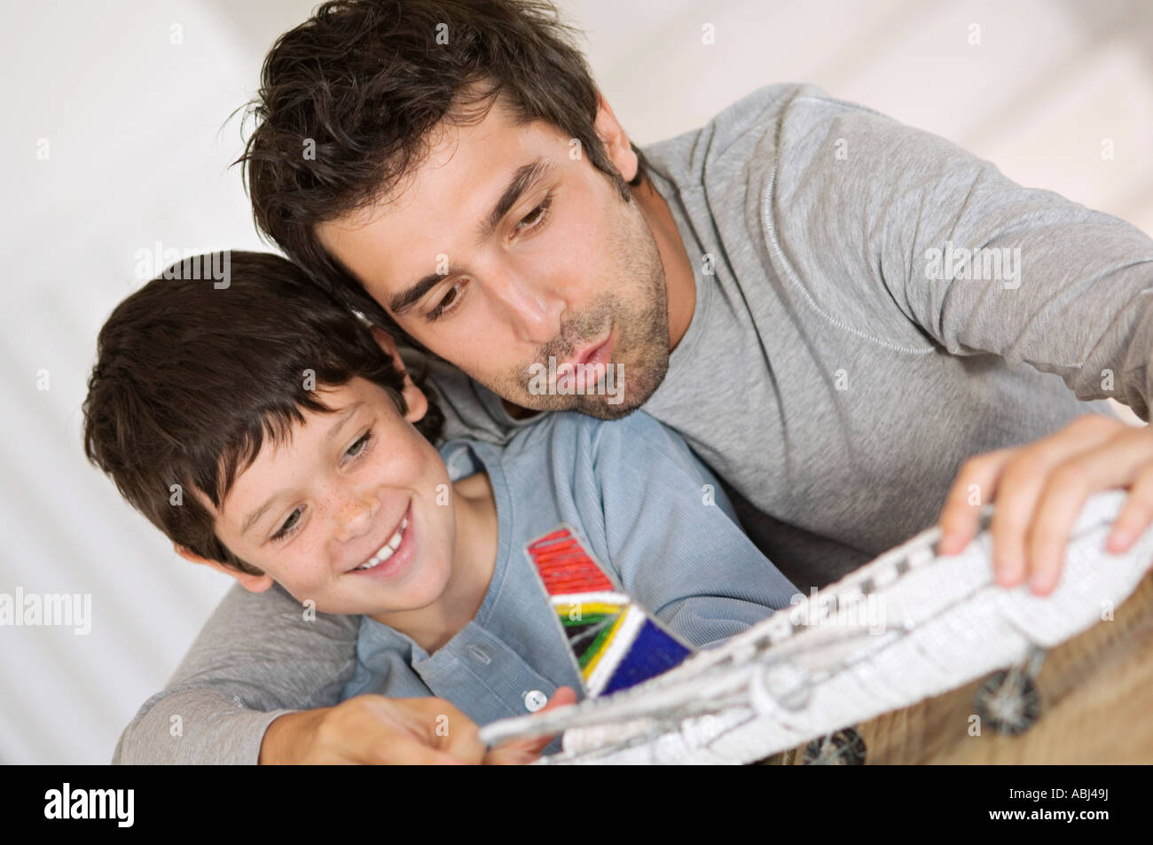 Father and son playing with model aeroplane Stock Photo - Alamy