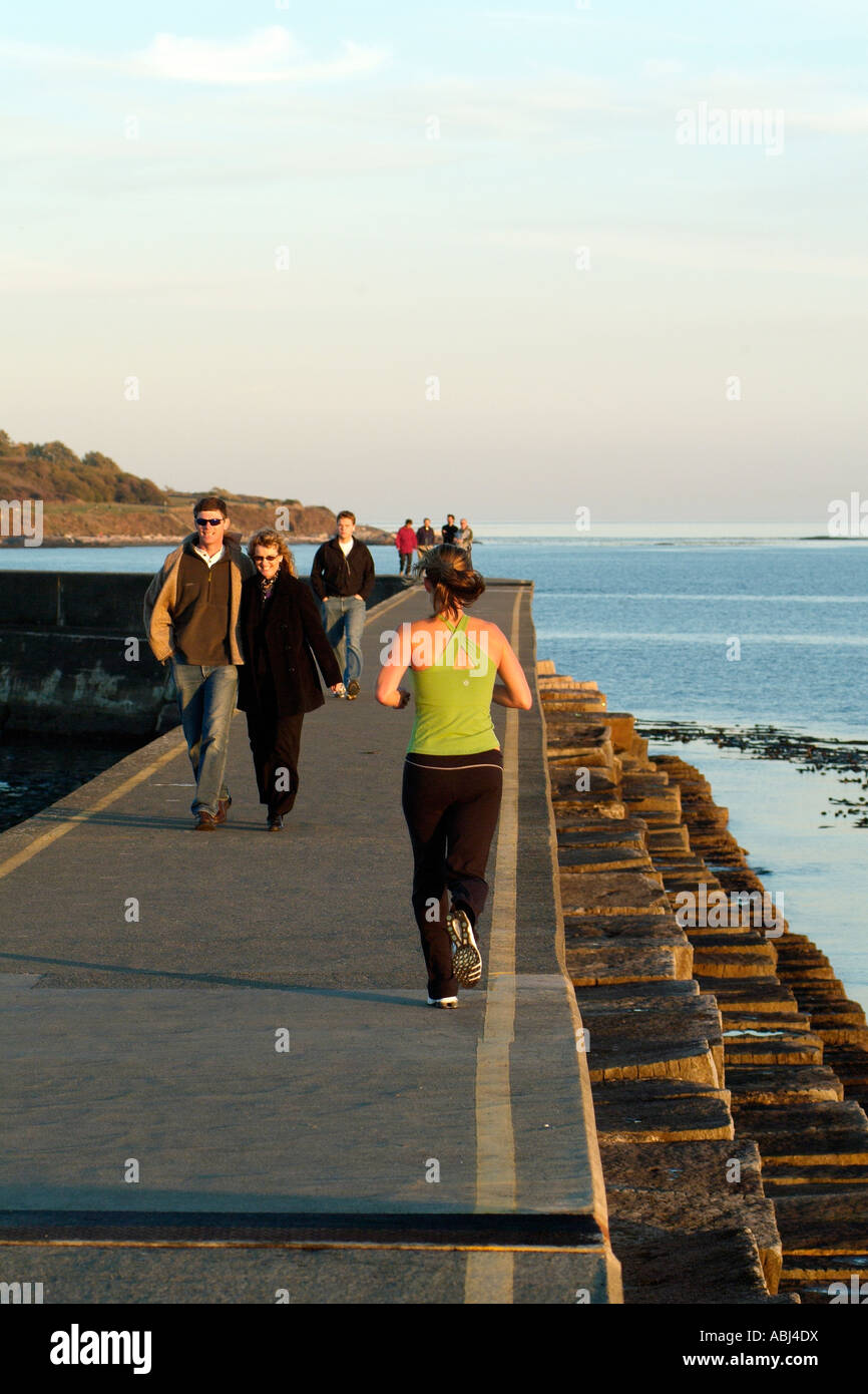 Woman running on a jetty in Victoria Stock Photo - Alamy