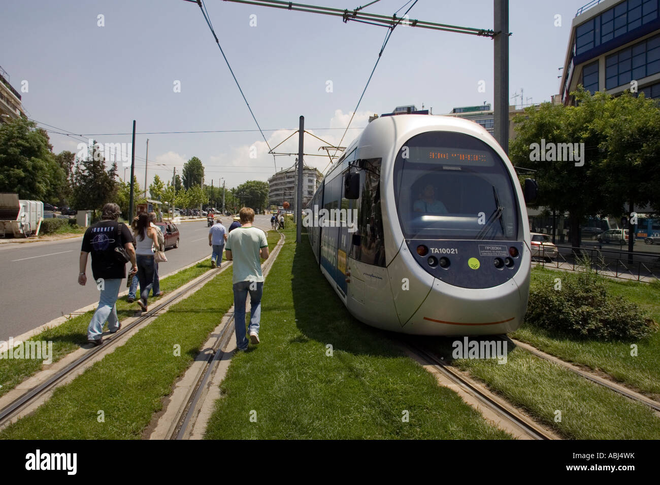 Athenians walking along the Athens tram lines Stock Photo - Alamy