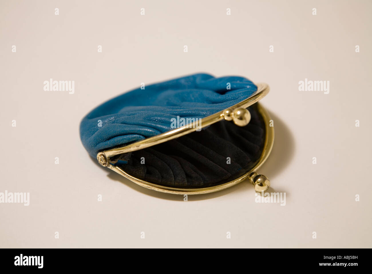 empty blue leather clam purse Stock Photo - Alamy