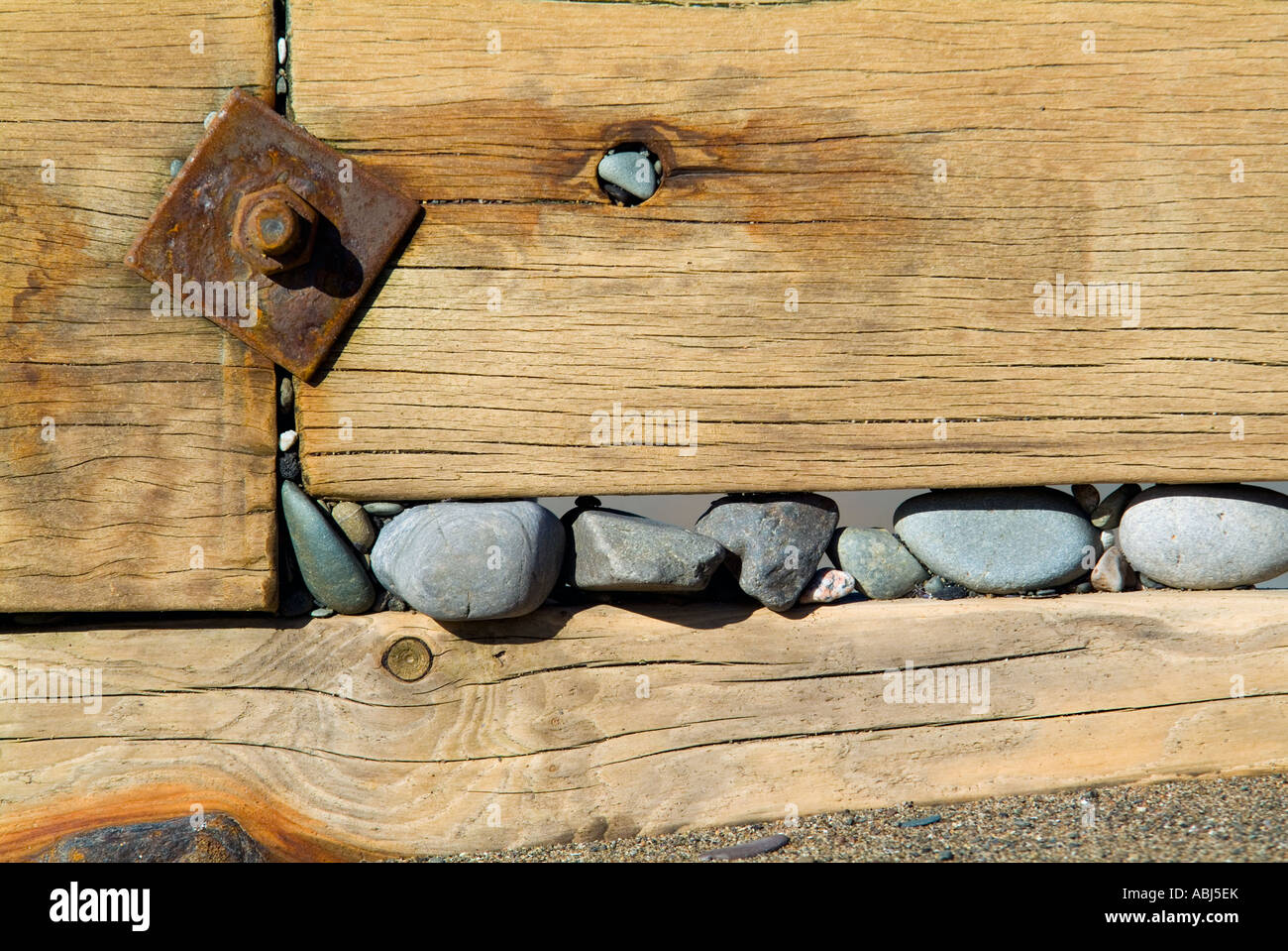 A modern art image featuring smooth pebbles and stones wedged into a ...