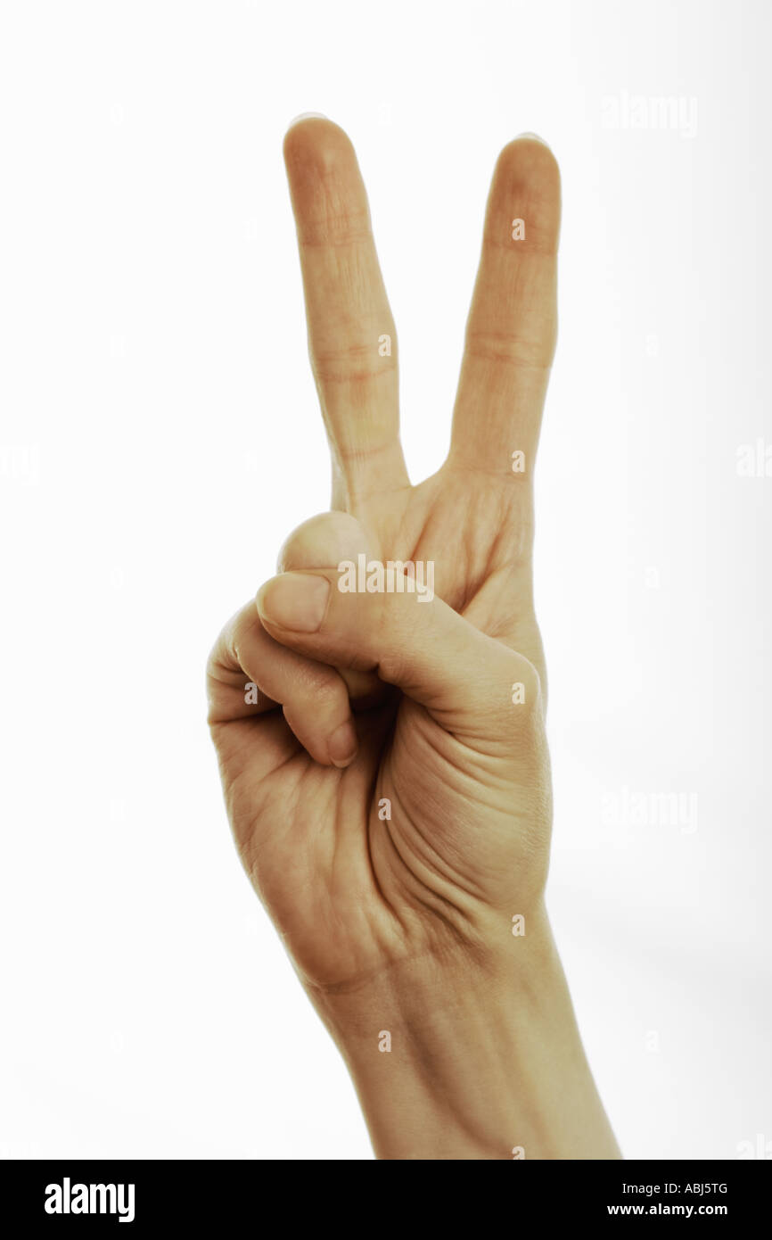Woman giving peace sign white background close up victory sign Stock ...