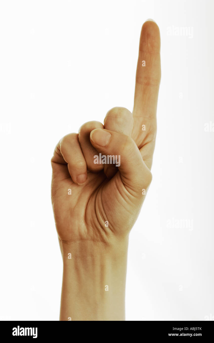 Woman holding up one finger white background close up Stock Photo - Alamy