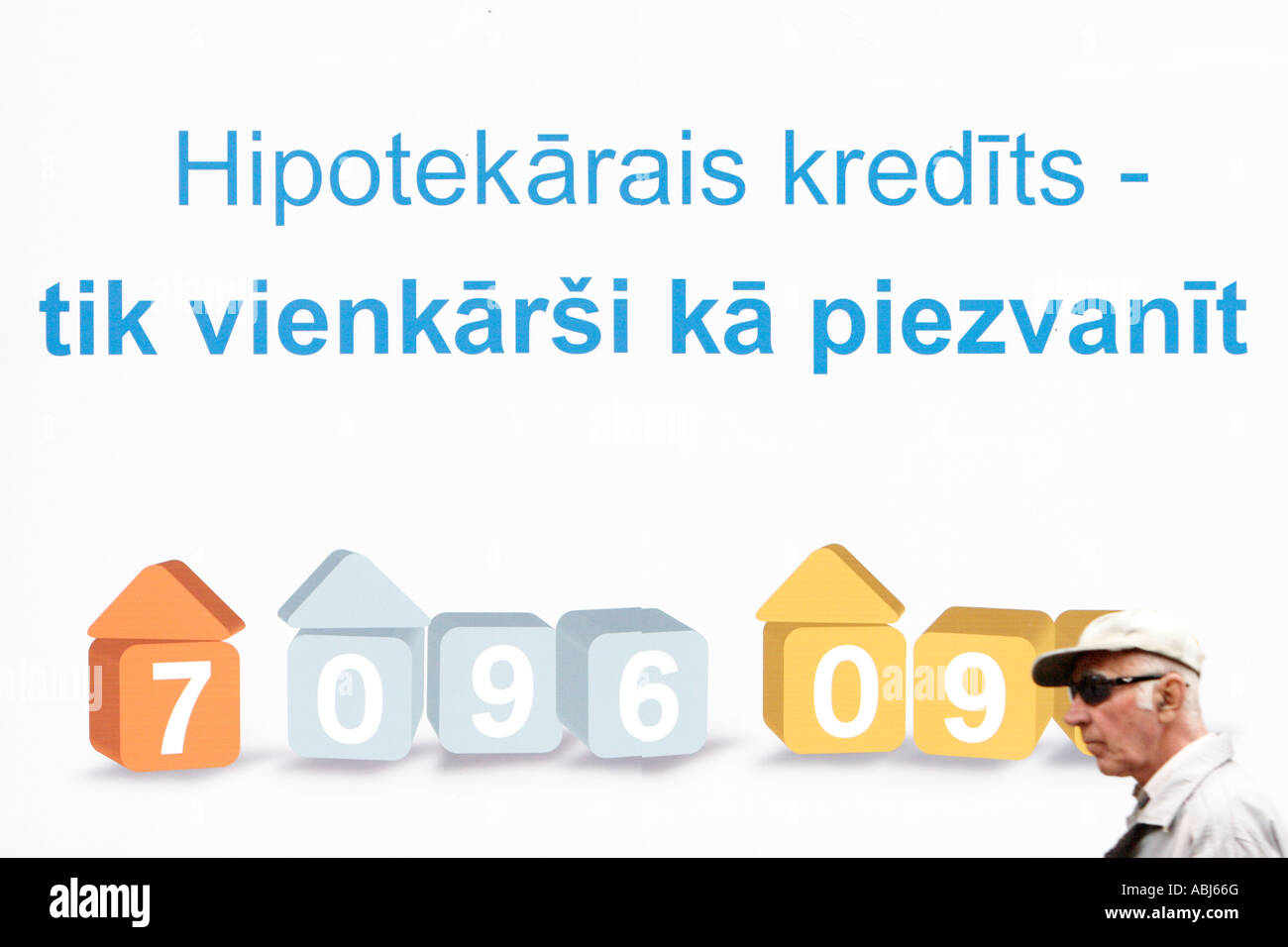 A pedestrian walks by hypothecary credit advertising poster in Riga ...