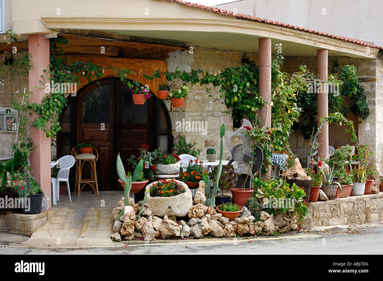 Small tavern decorated with pot flowers Stock Photo - Alamy