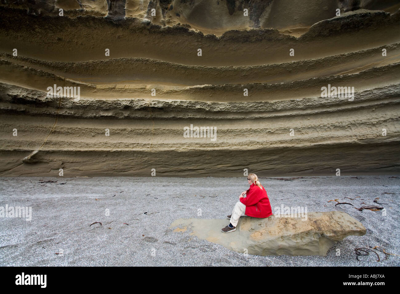 A person viewing the sedimentary layers of a cliff face Stock Photo - Alamy