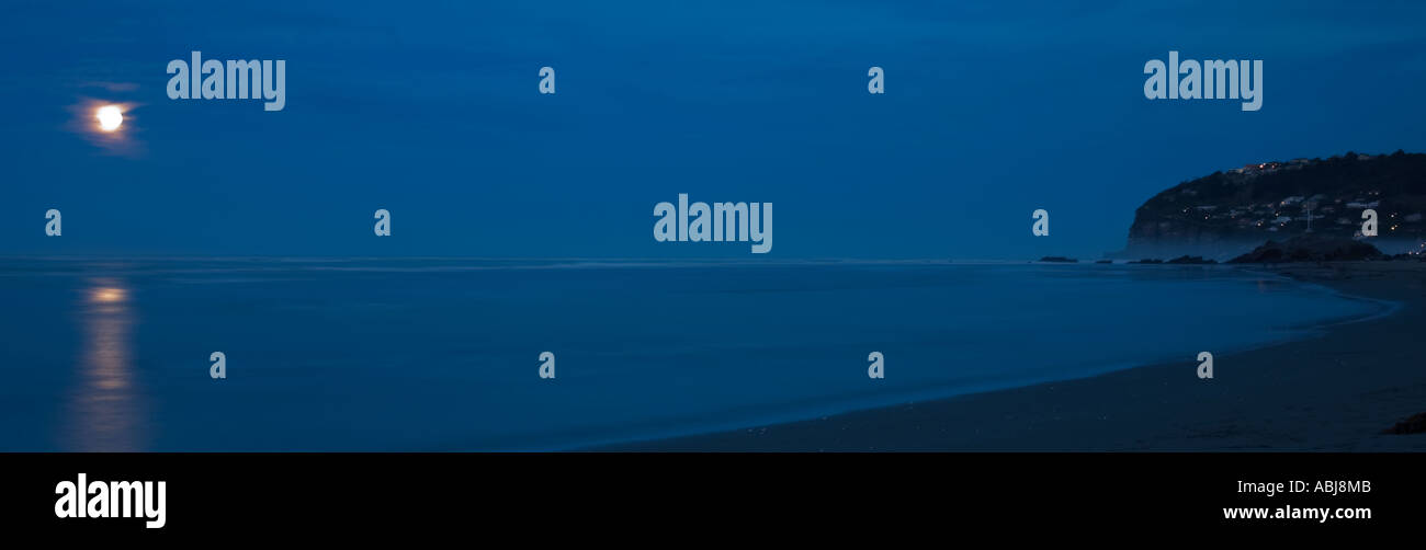 Full moon rising over the ocean Stock Photo - Alamy