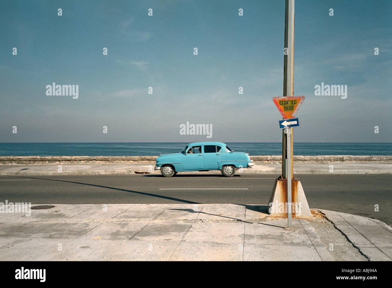 Blue car on road in front of ocean Stock Photo - Alamy
