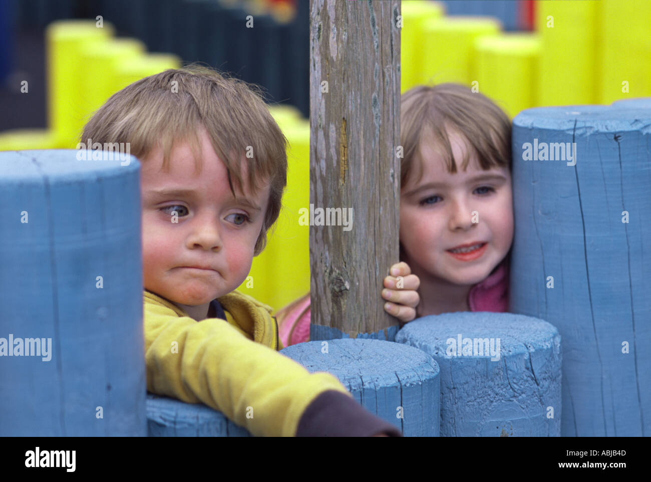 two friends 3 and 4 playing at the park maze Stock Photo - Alamy
