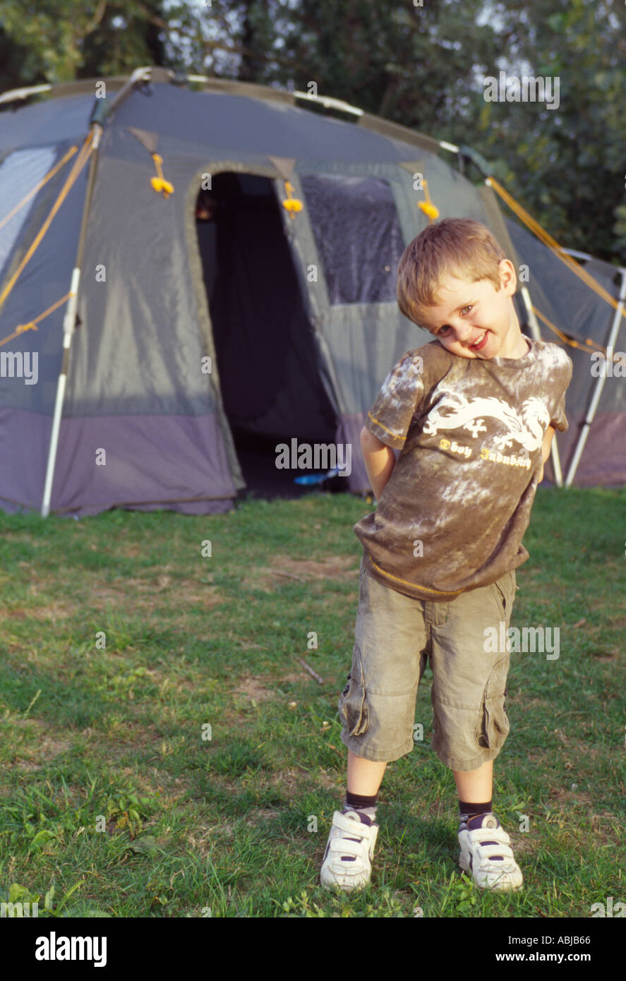 boy standing outside tent at campsite Stock Photo - Alamy