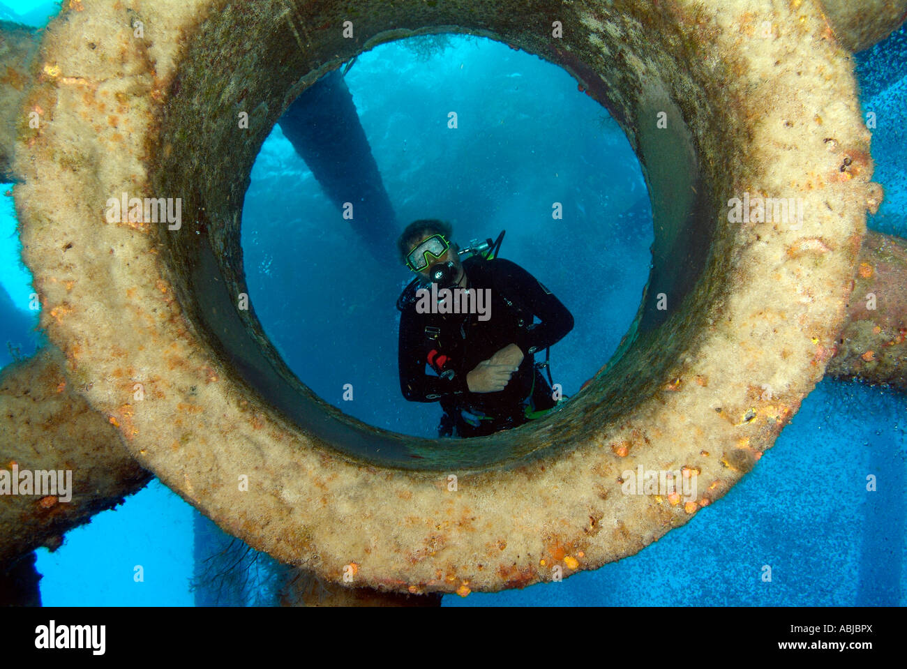 Scuba diver swimming in a rig in the Gulf of Mexico, off Texas Stock ...