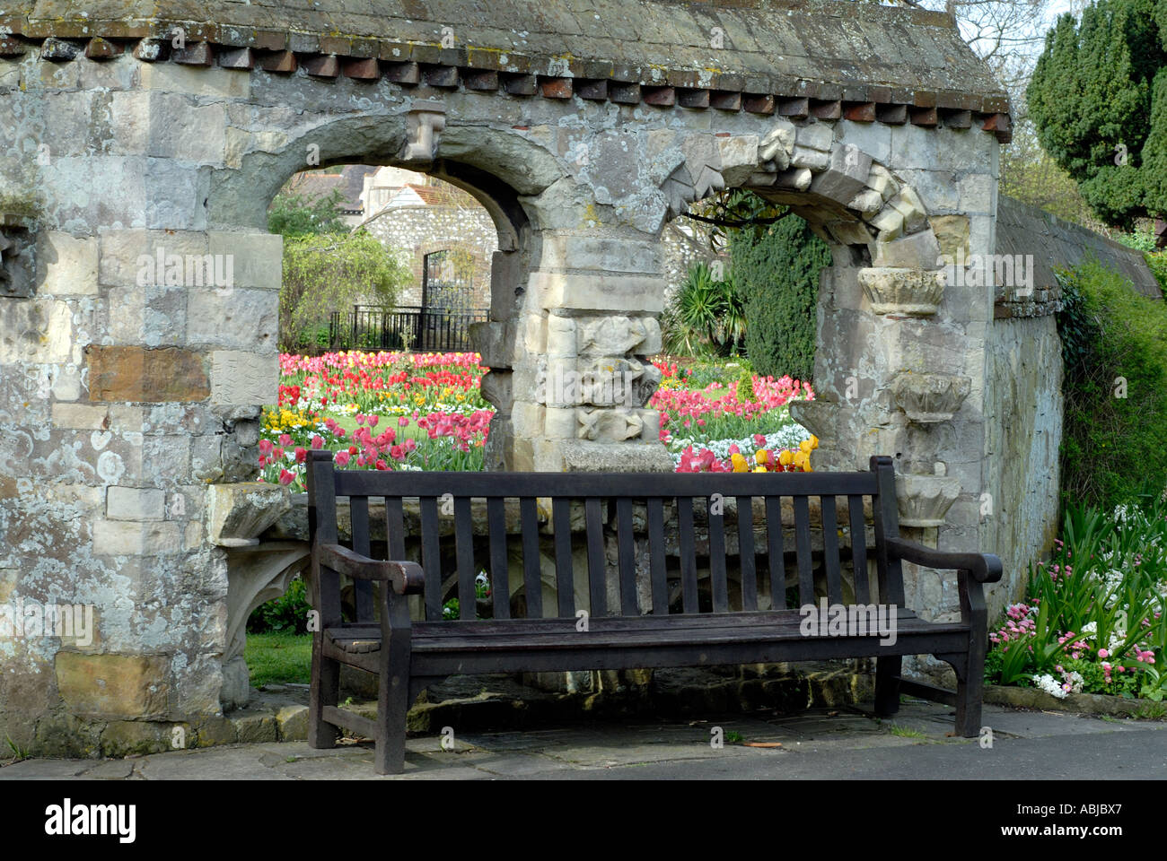 Southover Grange Gardens Lewes. View of garden bench with brightly ...
