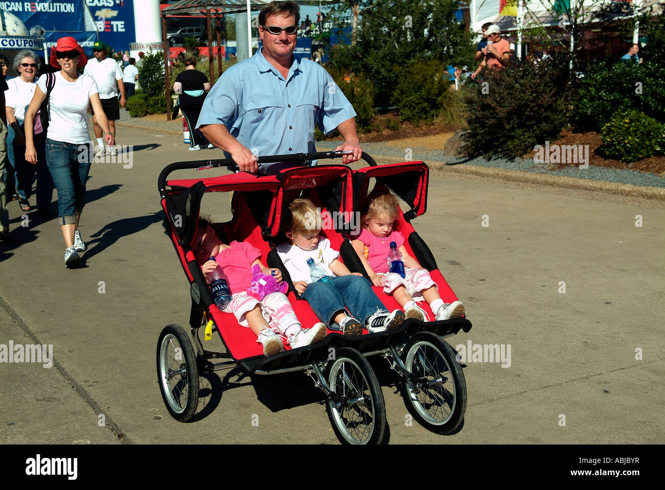 Man pushing a pushchair with children at the Dallas Fair Park Stock ...