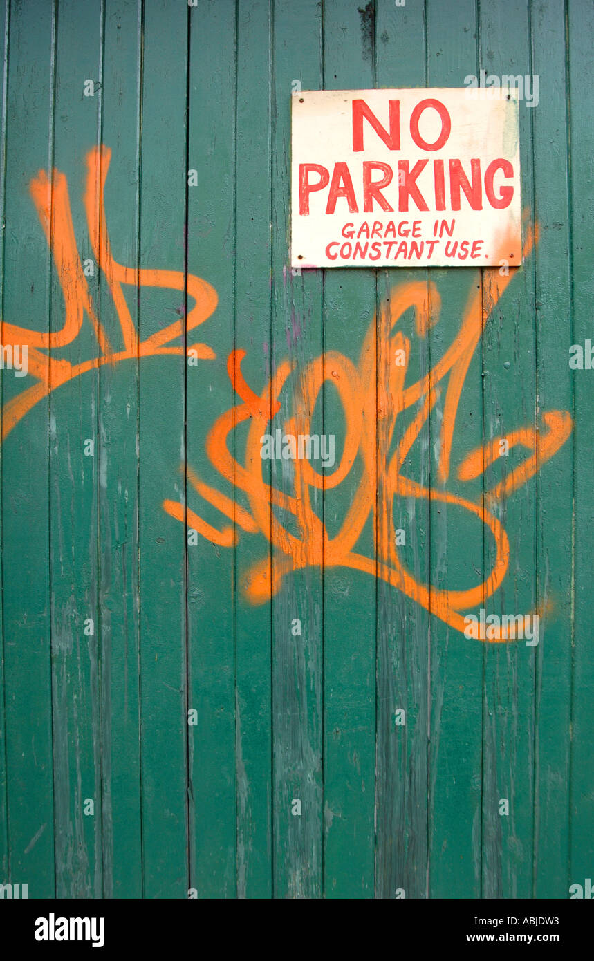 Graffiti door, no parking sign Stock Photo - Alamy