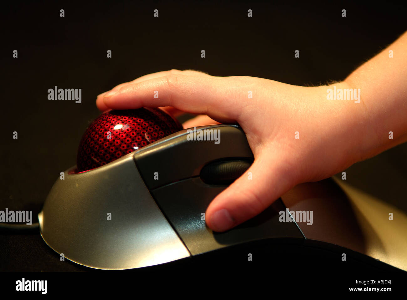 Young girl playing with a computer mouse on a table Stock Photo - Alamy