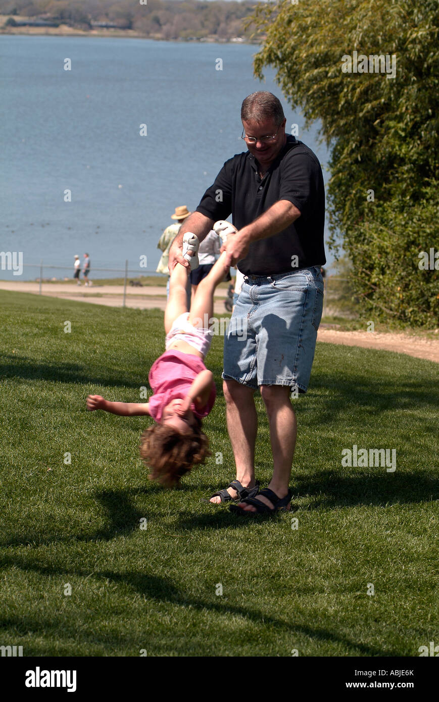 father and child playing on grass in a park Stock Photo - Alamy